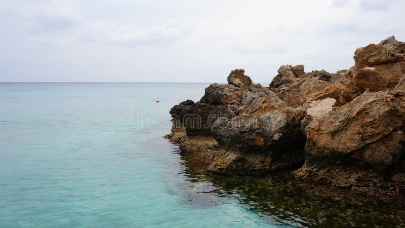 Mesmerizing View of the Ocean and the Rocky Coast Under the Blue Sky ...