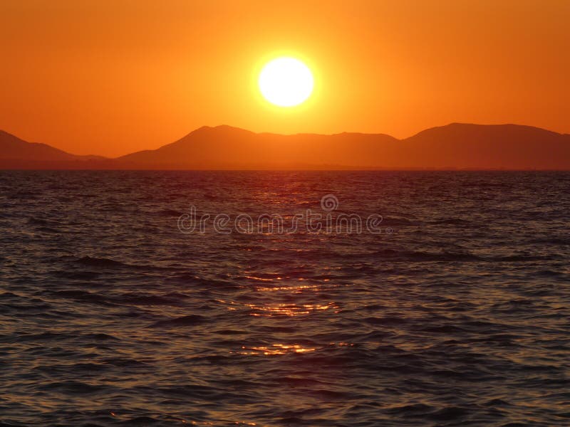 Mesmerizing View of a Partially Rough Sea during a Beautiful Sunset ...