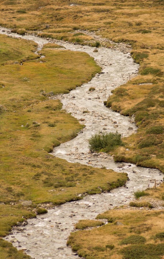 Mesmerizing View of a Small Winding River in the Field Stock Photo ...