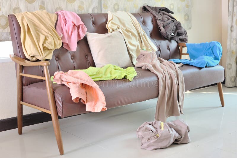 Messy Clothes Scattered on a Sofa in Room Stock Photo - Image of room ...