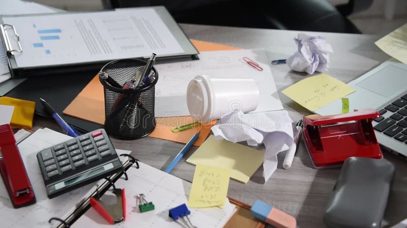 Messy and cluttered desk stock footage. Video of mess - 293976312