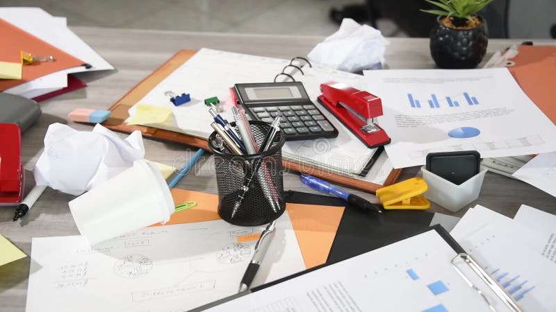 Messy and cluttered desk stock footage. Video of mess - 293976312