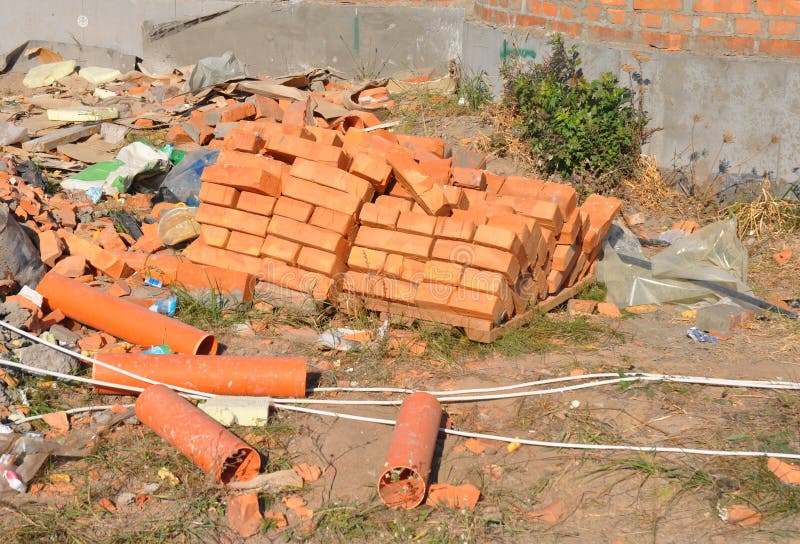 Messy Construction Site: a Pile of Red Brick, Staked Bricks among ...