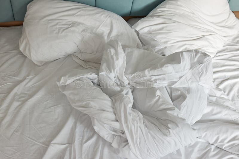 Messy hotel bed closeup stock photo. Image of white - 334690474