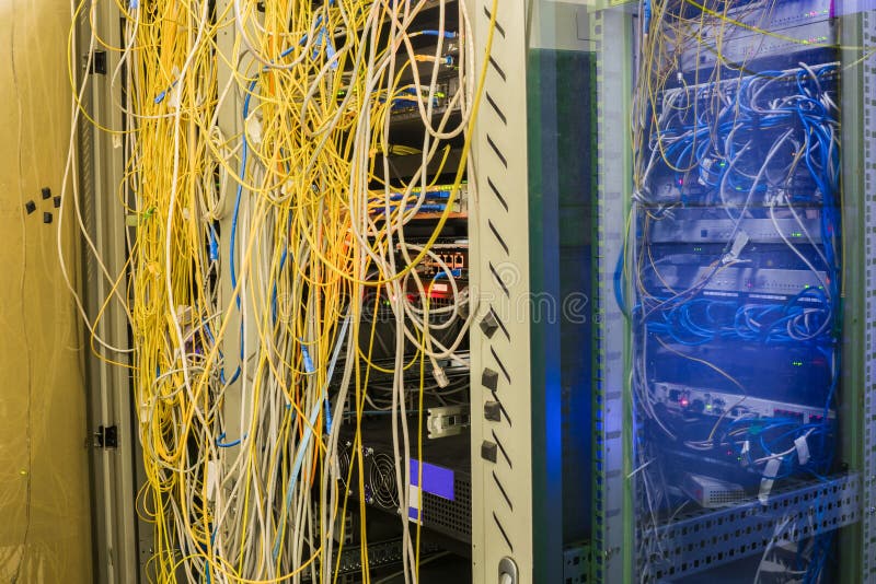 Messy Wires are in the Switch Rack. a Bright Display Glows on the ...