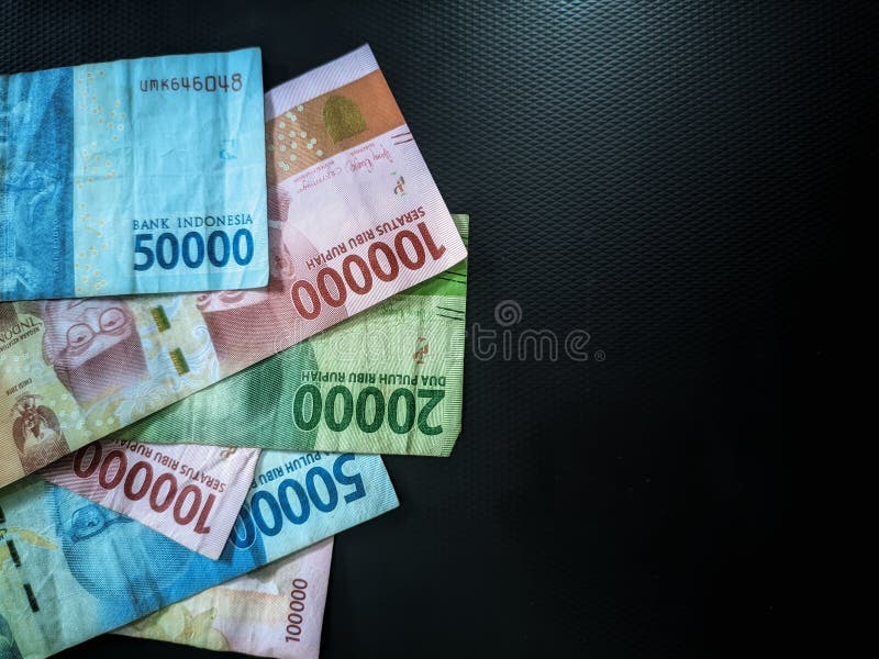 Messy money on black table stock image. Image of gadget - 263673015