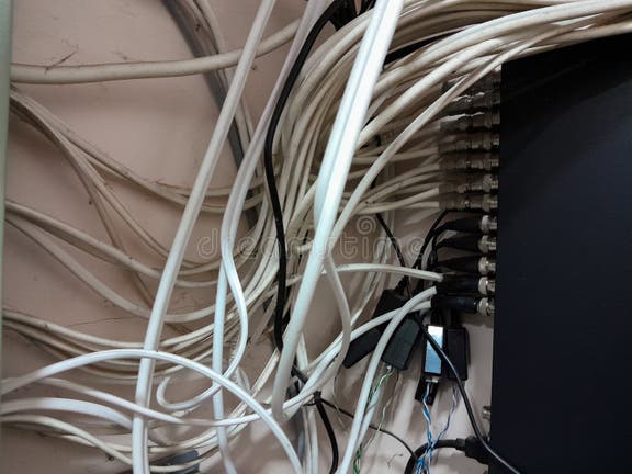 A Messy Pile of Tangled and Chaotic Network Cables on a Shelf Cupboard ...