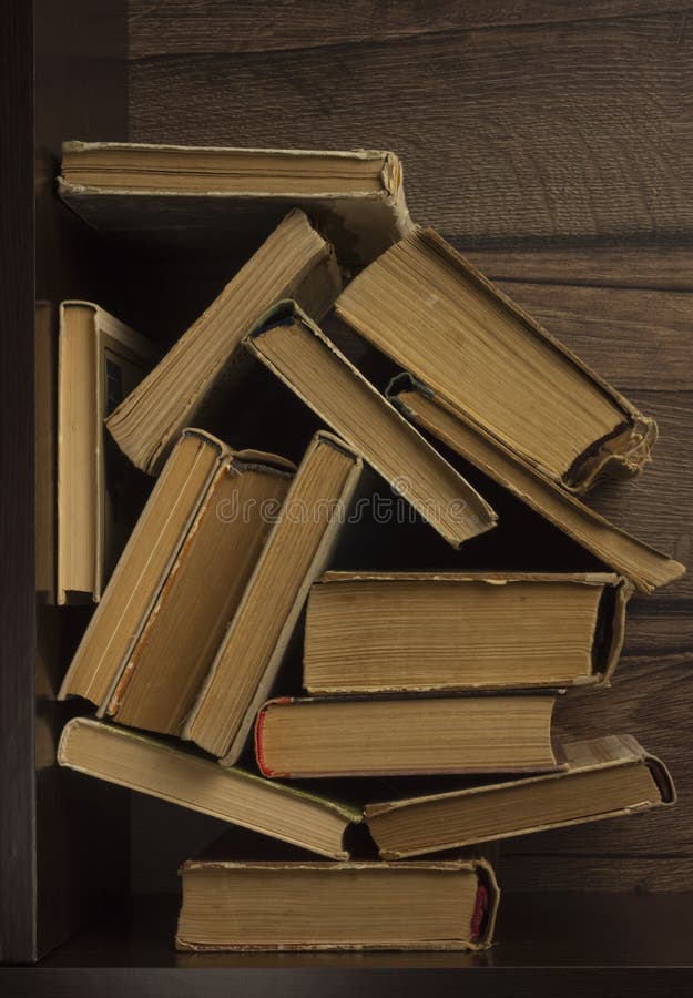 Stack of Old Paper Books on Dark Shelf, Vertical Image Stock Image ...