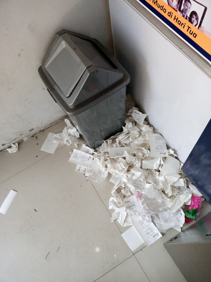 A Messy Trash Corner in a Car Workshop with Three Plastic Bins ...