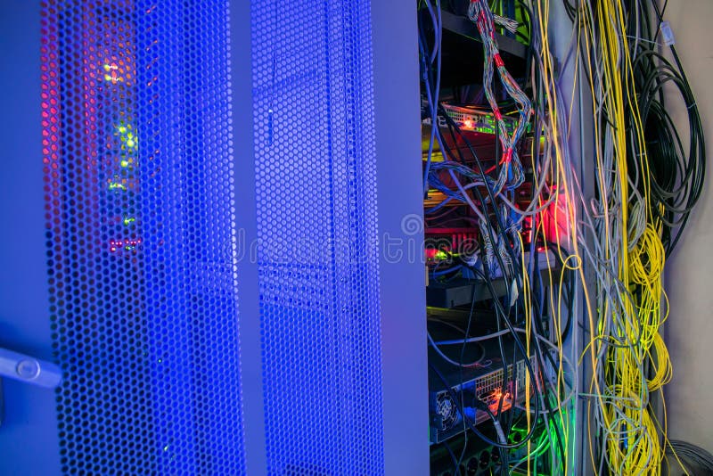 Messy Wires are in the Switch Rack. a Bright Display Glows on the ...