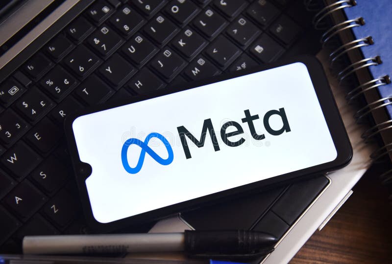 Meta Logo is Seen on a Smartphone Screen on a Table with Objects in the ...