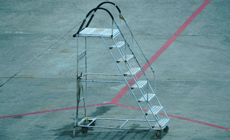 A Metal Aircraft Boarding Ladder, Positioned on a Gray Concrete Surface ...