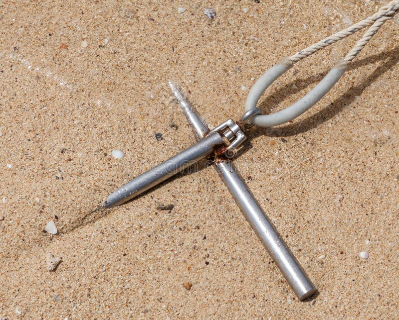 Metal Anchor with Rope Fixed in the Sand at Seashore Stock Image ...