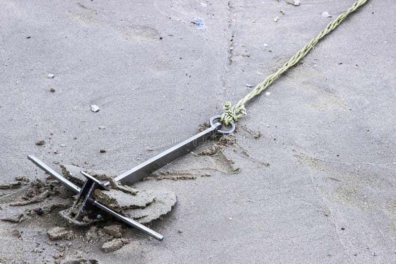 Metal Anchor with a Tied Rope on the Sand Stock Photo - Image of ...