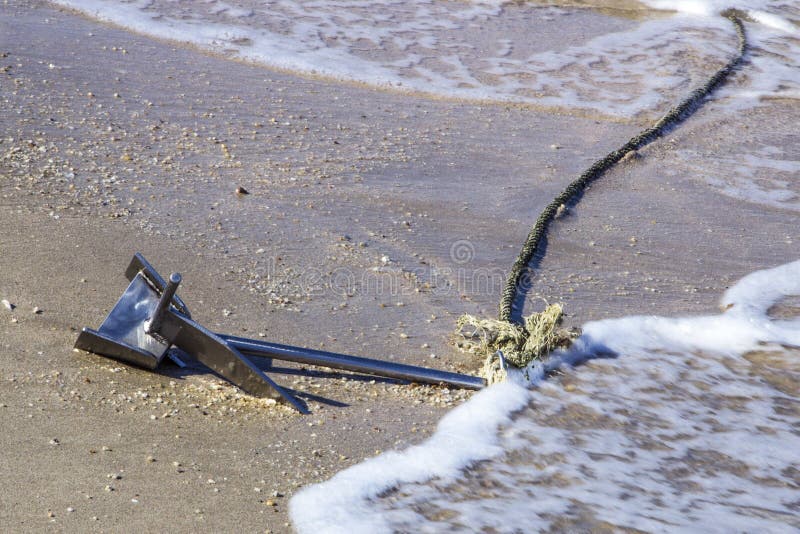 Metal Anchor with a Tied Rope on the Sand Stock Photo - Image of ...