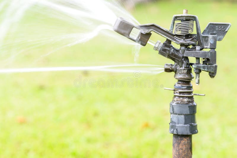 Metal Automatic Water Sprinkler Stock Image - Image of garden, field ...