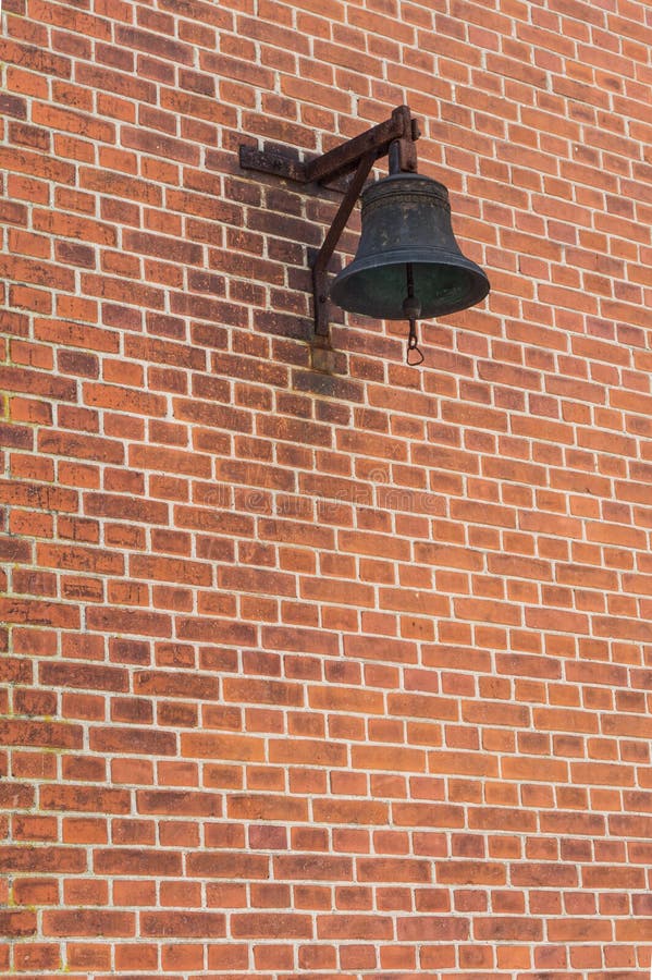 Metal Bell on a Red Brick Wall Stock Photo - Image of vertical, bell ...
