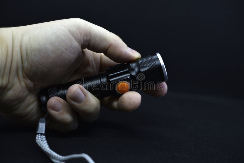 Metal Black Flashlight in Hand. Pocket Flashlight Stock Image - Image ...