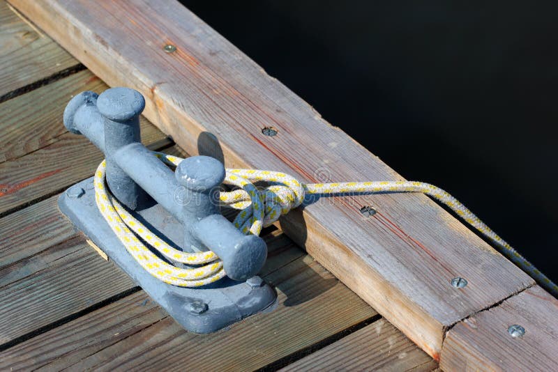 Metal Bollard with Rope on a Pier Stock Image - Image of line, port ...
