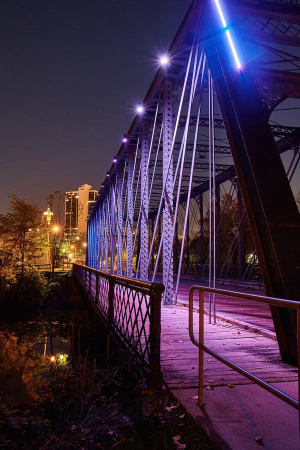 Metal Bridge Leading into a Town is Lit Up Purple at Night Stock Image ...