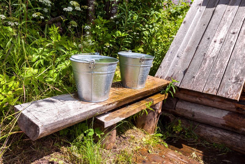 Metal Buckets with Cool Water Standing on a Bench Stock Photo - Image ...
