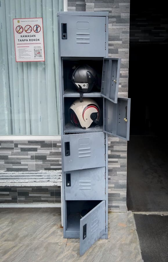 Metal Cabinet with Broken Doors and with Helmets on in Stock Image ...