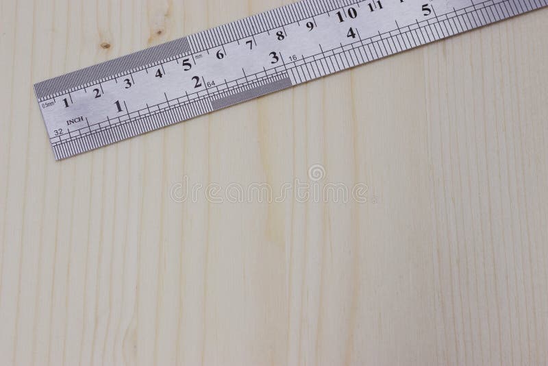 Metal Carpentry Ruler on a Light Wooden Background Stock Image - Image ...