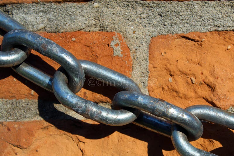 Metal Chain Lying on Terracotta Bricks Wall Stock Photo - Image of ...