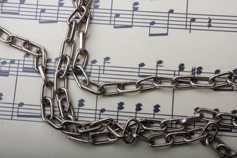 Metal Chain Placed on Paper with Musical Notes Stock Photo - Image of ...