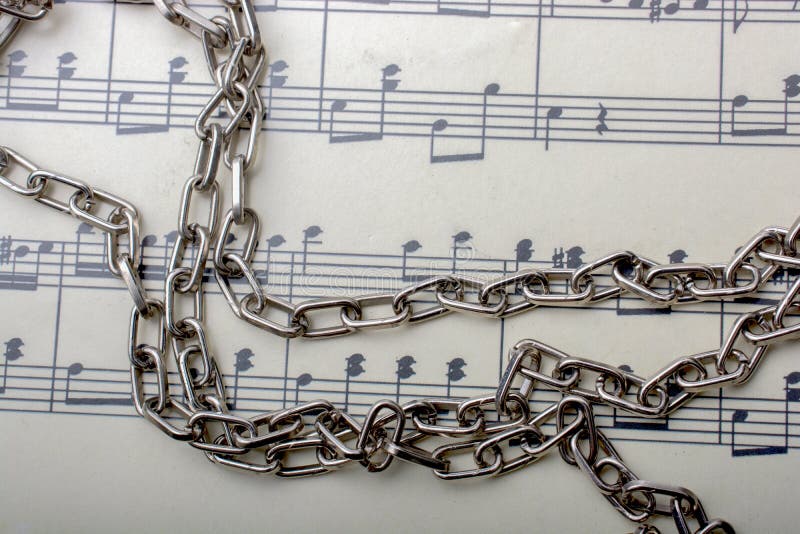 Metal Chain Placed on Paper with Musical Notes Stock Photo - Image of ...