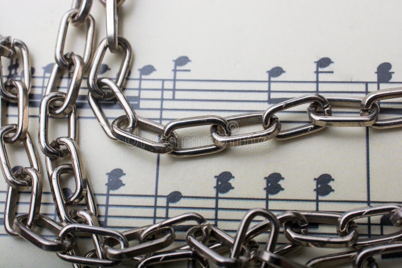 Metal Chain Placed on Paper with Musical Notes Stock Photo - Image of ...