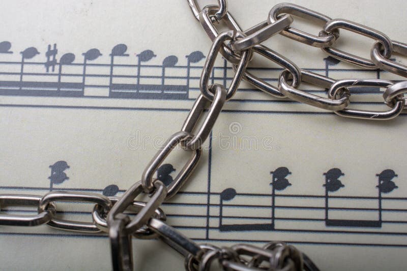 Metal Chain Placed on Paper with Musical Notes Stock Photo - Image of ...