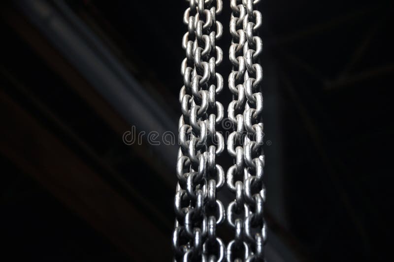 Metal Chains Dangling and Illuminated with Bright Light. Stock Image ...