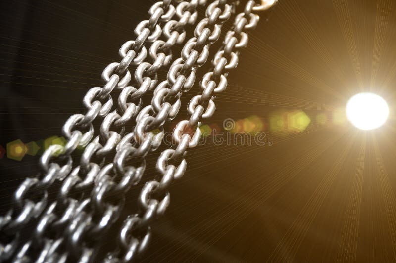 Metal Chains Dangling and Illuminated with Bright Light. Stock Photo ...