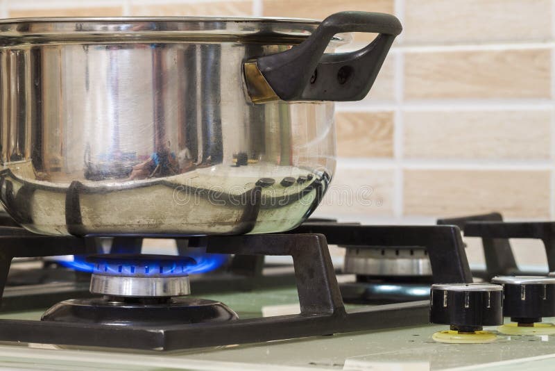 Metal Cooking Pot Standing on Kitchen Stove with Flame. Stock Photo ...