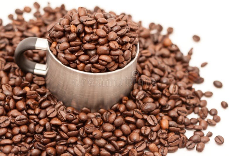 Metal cup on coffee beans stock image. Image of insulated - 24423873