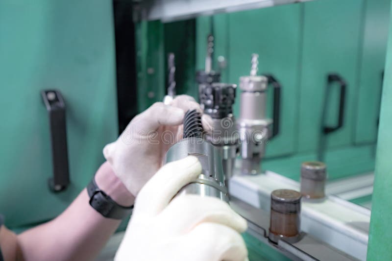 Metal-cutting Cutters for a CNC Machine in the Hands of a Worker To ...