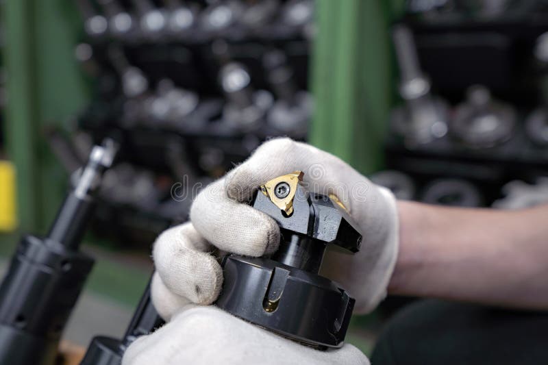 Metal-cutting Cutters for a CNC Machine in the Hands of a Worker To ...