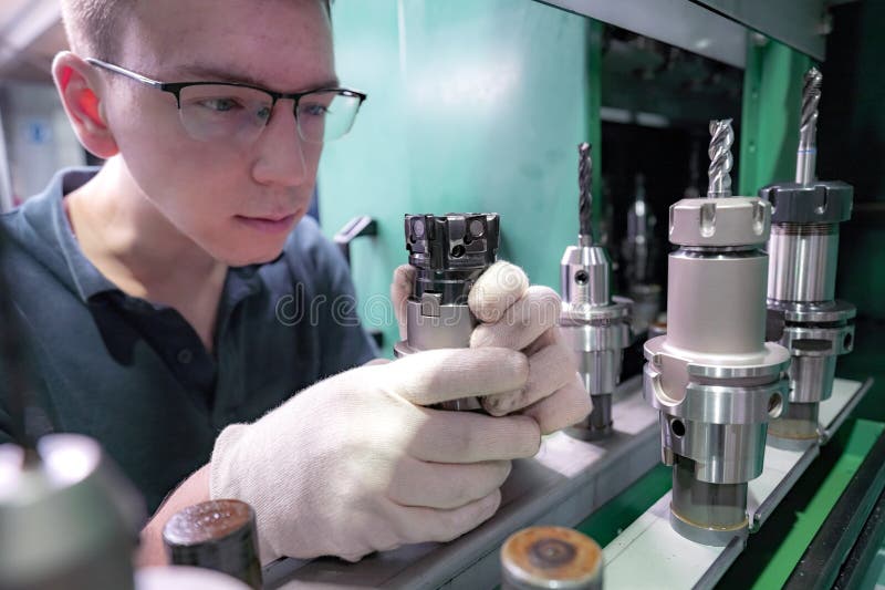 Metal-cutting Cutters for a CNC Machine in the Hands of a Worker To ...
