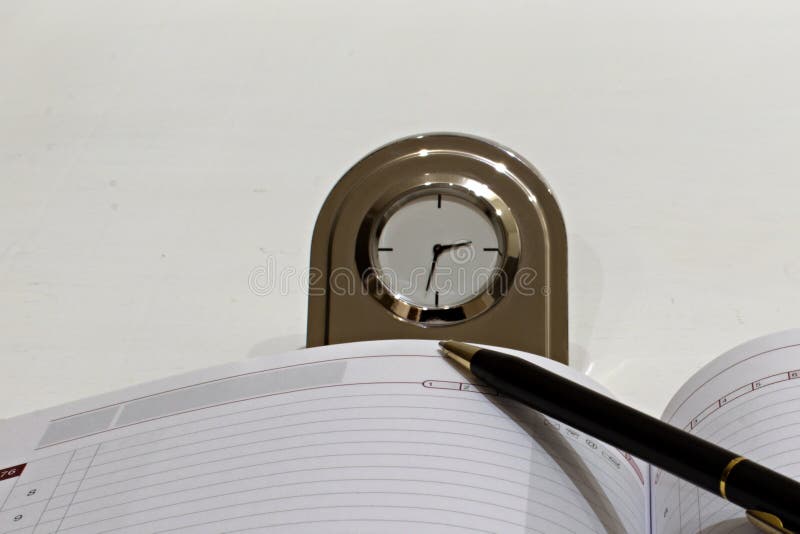 Metal Desk Clock with Diary and Ballpoint Pen Stock Photo - Image of ...