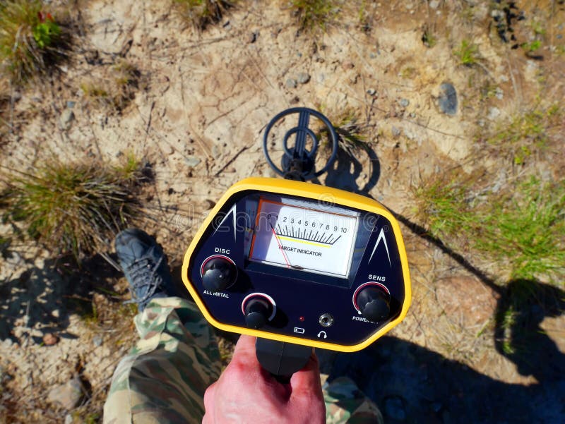The Use of a Metal Detector on the Ground. Searching for Objects with a ...