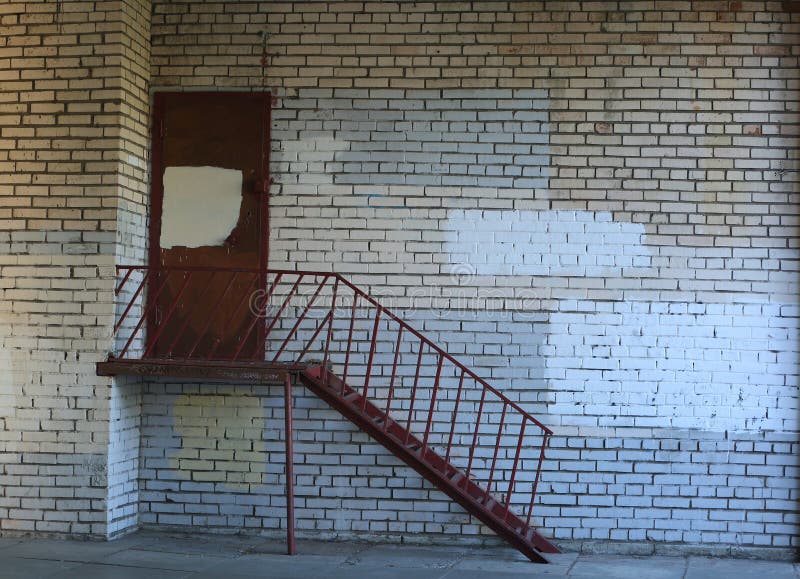 Metal Door with Metal Ladder in Brick Wall Stock Photo - Image of ...