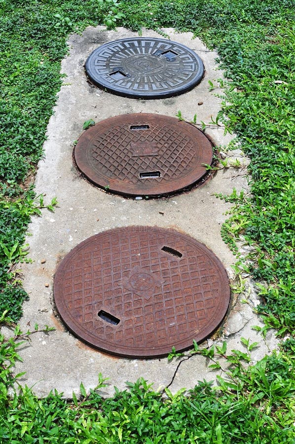 Metal Drain Lid or Manhole Cover on Ground Stock Image - Image of plant ...
