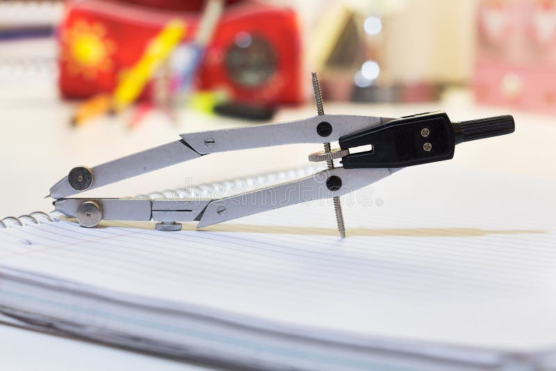 A Metal Drawing - Drafting Compass on a Notebook. Stock Photo - Image ...