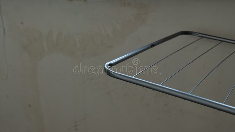 A Metal Drying Rack Positioned Elegantly Against a Bare Wall for ...