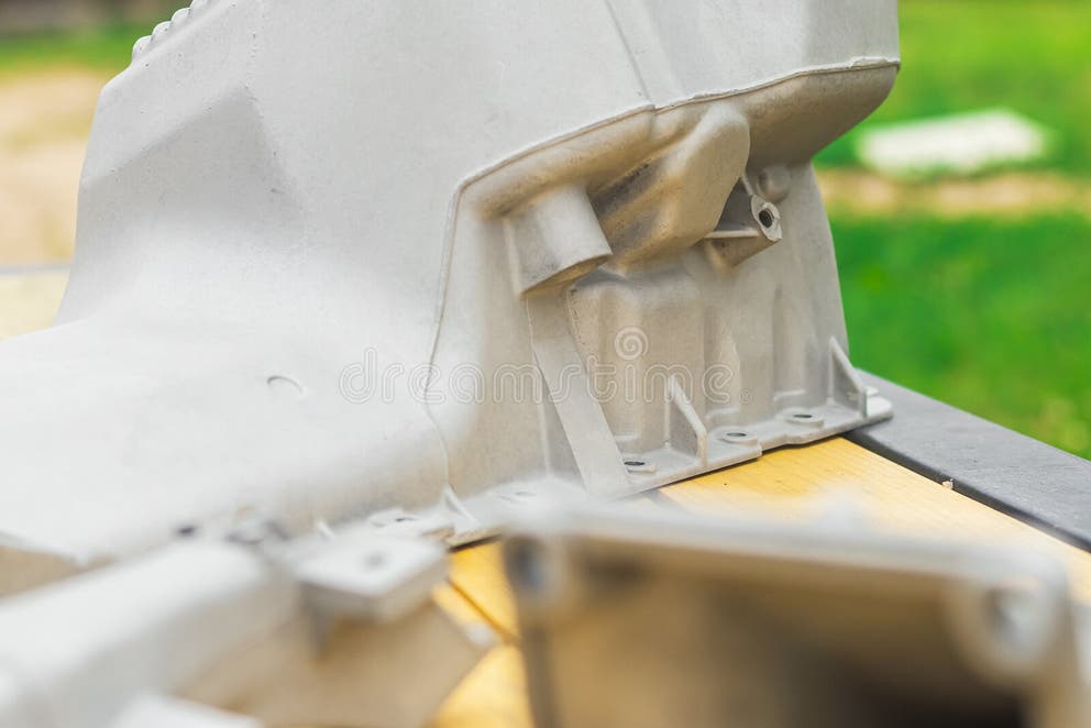 Metal Engine Component Displayed Against a Textured Gray Background ...