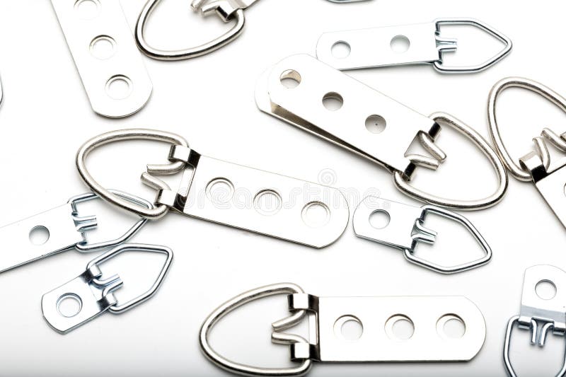 Metal Fasteners and Hooks Scattered on a White Surface. Various Shapes ...