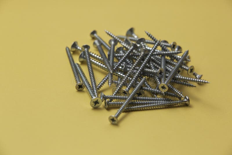 Metal Fasteners on a Yellow Background Stock Image - Image of nails ...