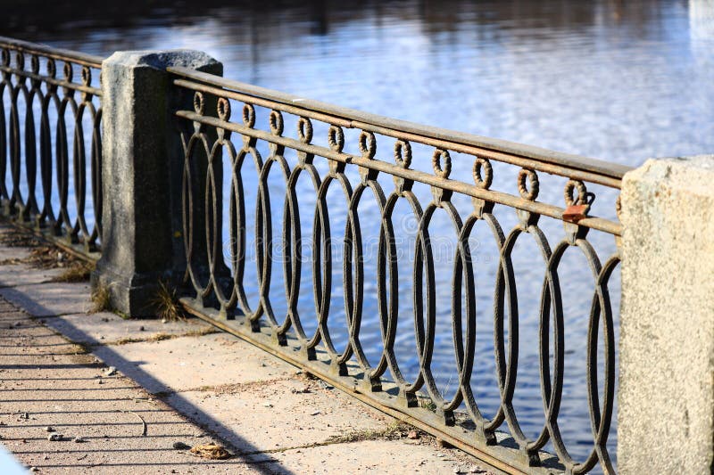A Metal Fence Alongside a Body of Water Stock Image - Image of shore ...