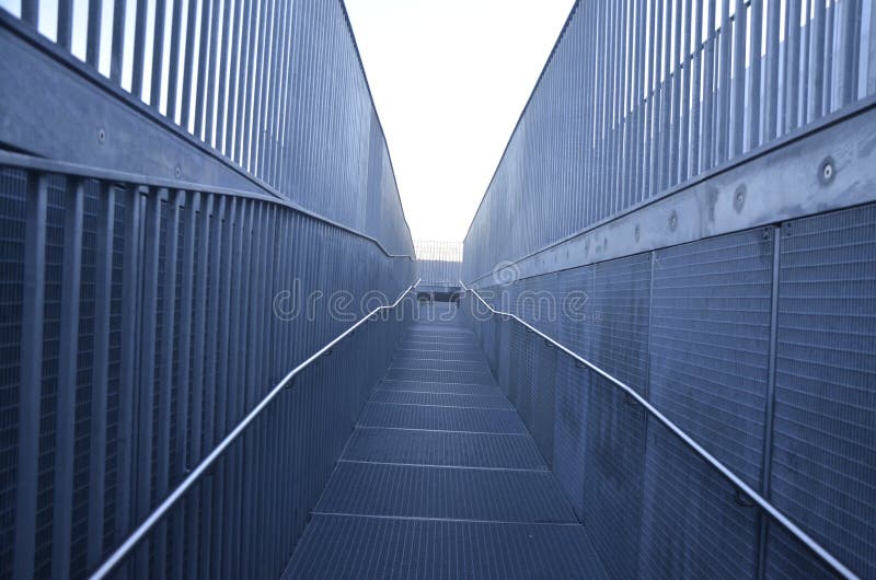 Metal fencing and walkway stock photo. Image of sunny - 82892476